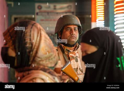 Indian Paramilitary Trooper Is Deployed As Women Voters Wait In A Queue
