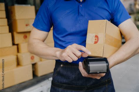 Asian Delivery Man Hand Using Smart Phone To Scan QR Code On Tag Concept Of Parcel Delivery
