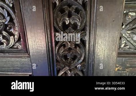 Detailed Hand Carved Floral Motifs Adorn The Wooden Wall Of A