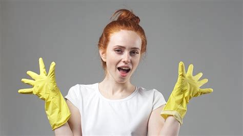 Pembantu Muda Yang Cantik Dengan Sarung Tangan Karet Kuning Senyum