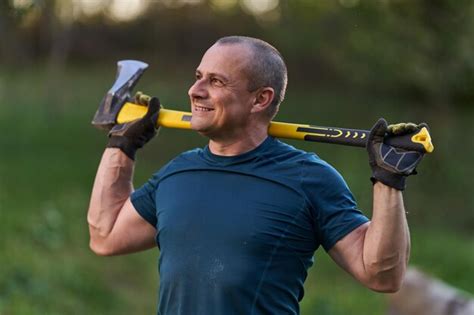 Premium Photo Farmer With Big Axe Splitting Beech Logs