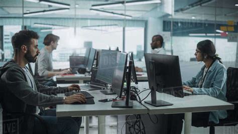 Diverse Multi Ethnic Team Working In Big City Office It Programmers Working On Desktop