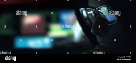 Nerd Hacker With Glasses Working With A Computer In The Dark