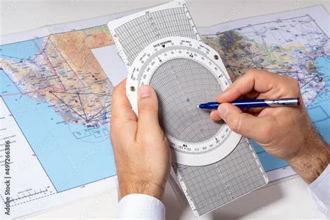 The Pilot Uses A Navigation Computer Route Calculation Drawing Up A Flight Plan Using Maps