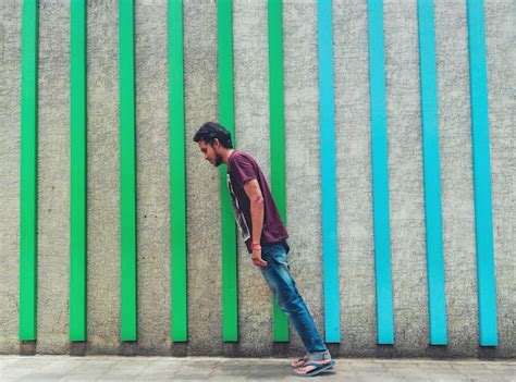 Premium Photo Side View Of Young Man Leaning Against Wall