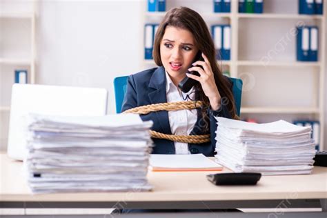 The Young Beautiful Employee Tied Up With Rope In The Office Young Beautiful Employee Tied Up