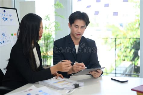 Professional Business Team Analyzing Data On Digital Tablets And