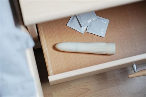 Premium Photo Condoms And Vibrator Dildo In Bedside Table Or
