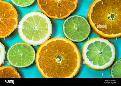 Selection Of Slices Of Citrus Fruit On A Bright High Contrast Turquoise