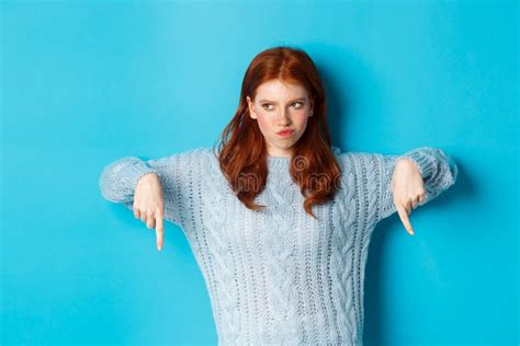 Winter Holidays And People Concept Indecisive Redhead Girl In Sweater