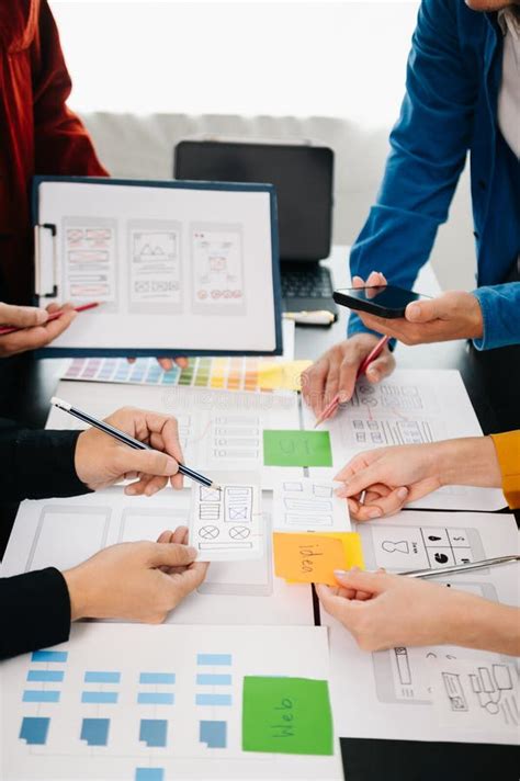 Ux Developer And Ui Designer Brainstorming About Mobile App Interface