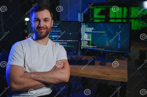 Male Programmer Working On Desktop Computer At White Desk In Office