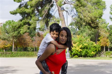 Happy Mother And Son Enjoying Together Outdoors In A Park Stock Photo Image Of People