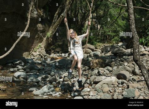 Girl Sitting On Tree Root Swing Stock Photo Alamy