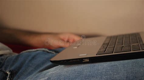 A Man Watches A Pornographic Website On His Laptop Which Is On His Lap And Masturbates With His
