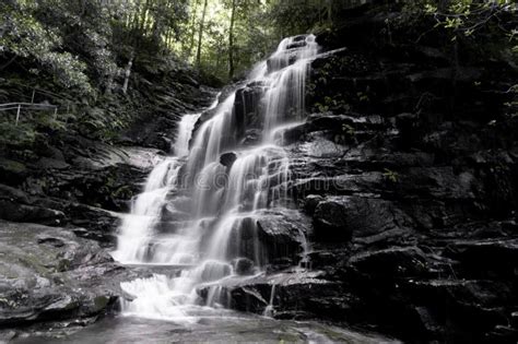 Small Cascading Waterfall Over Rocky Terrain In A Picturesque Outdoor Setting Stock Image
