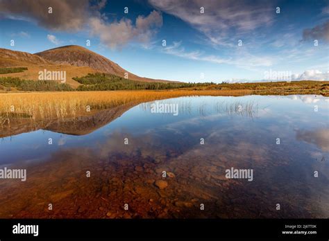 Red Cuillins Reflecting In Loch Cill Chriosd On The Isle Of Skye Stock