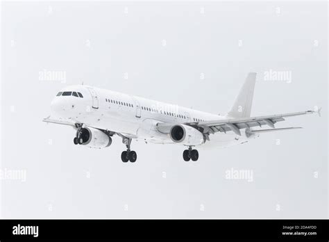 White Plane With Chassis In The Sky Landing Mode Passenger Airplane