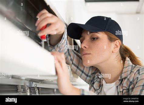 Woman Unscrews The Fixing Screws Of The Window Handle Stock Photo Alamy