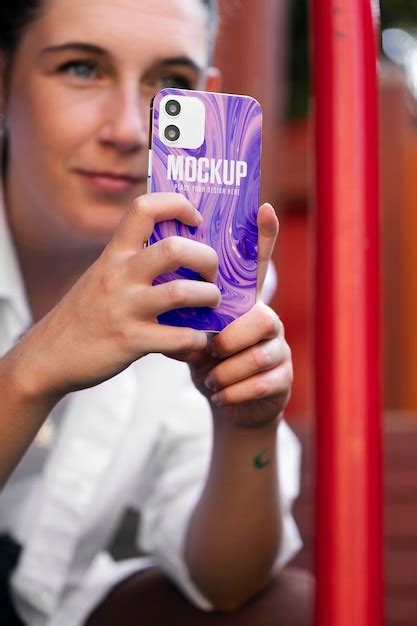 Premium PSD Woman Using Mock Up Smartphone Outdoors To Take Picture