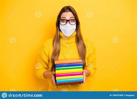Portrait Of Nice Healthy Stunned Girl Nerd Wearing Safety Mask Holding In Hands Pile Book Learn