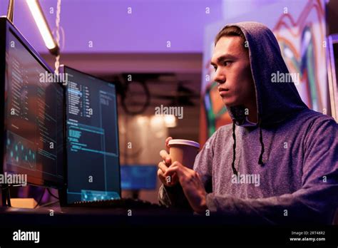 Asian Hacker Drinking Coffee And Doing Ddos Attack On Website Criminal Breaking Into Network