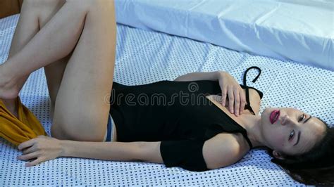Close Up Beautiful Brunette With Long Legs Posing On Bed Stock Image