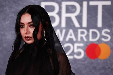 Charli Xcx Wows In Hooded Black Naked Dress At 2025 Brit Awards