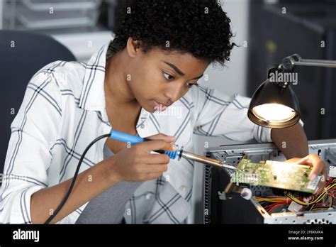 Woman Soldering Elements Of Circuit Board Stock Photo Alamy