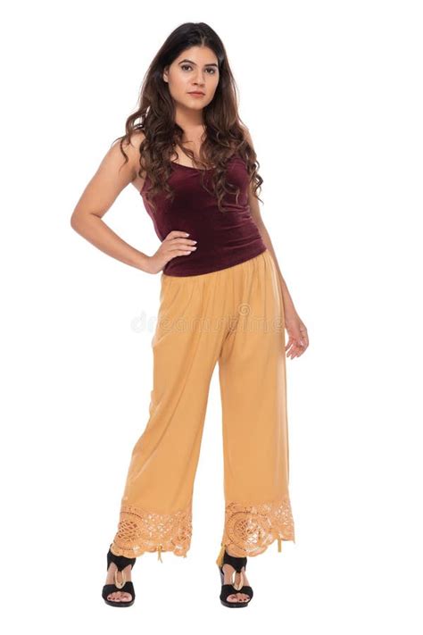 Indian You Girl With Red Velvet Camisole And Loose Pants With Elegant