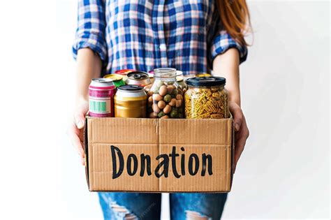 Woman Holding Donation Box With Food Items For Charity Concept Of