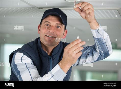 Man Replacing Ceiling Light Bulb Stock Photo Alamy