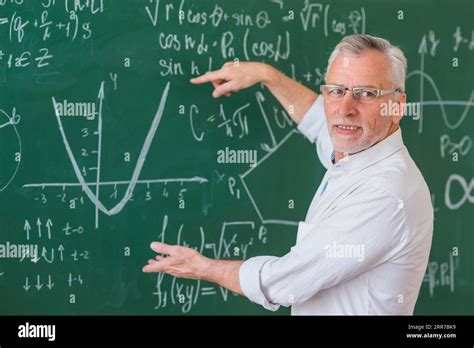 Senior Teacher Glasses Explaining Math Example Green Chalkboard Stock