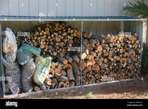Storage Shed With Stacks Of Firewood Logs Seasoned And Ready To Use In Wood Burning Stove