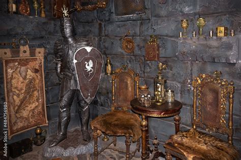 Knight Armor With Shield In Medieval Castle Room With Table Chairs