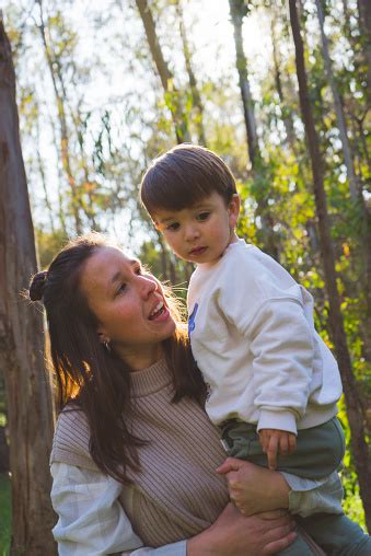 젊은 어머니는 작은 아들과 함께 공원과 숲을 통해 태양과 자연을 즐기며 사랑으로 가득 찬 출산을 한 가족으로 걷습니다 2 3 살에 대한 스톡 사진 및 기타 이미지 Istock