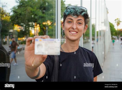 Smiling Non Binary Gender Showing Their Id Identity Document In Lgbt Smiling Non Binary Gender Showing Their Id Identity Document In Lgbt