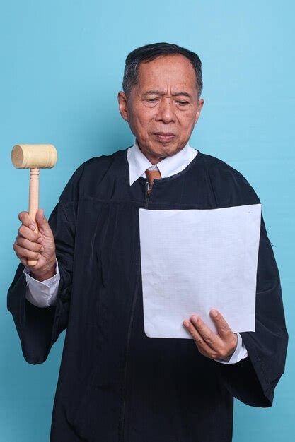 Premium Photo Serious Asian Judge Male Dressed In Robe Gown Uniform