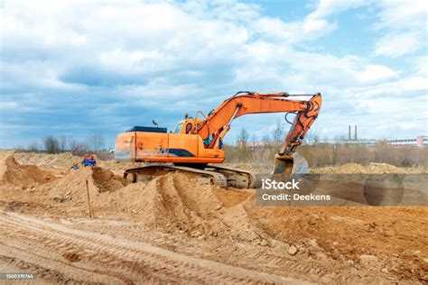 굴삭기는 건설 현장에서 참호를 파는다 외부 하수도 파이프를 놓는 트렌치 다층 건물을 위한 하수 배수 시스템 구덩이 기초를 파고