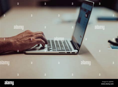 Business Man Hand Working On Blank Screen Laptop Computer On Wooden Desk As Concept With Social
