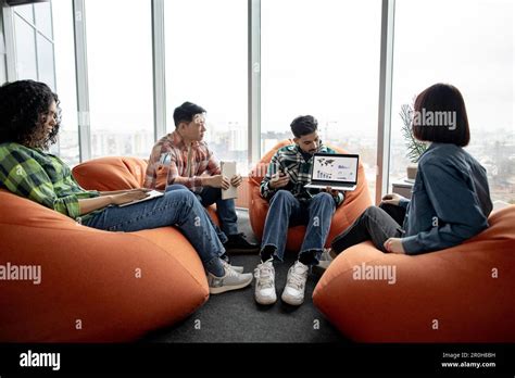 Team Of Confident Entrepreneurs Looking At Laptop Screen While