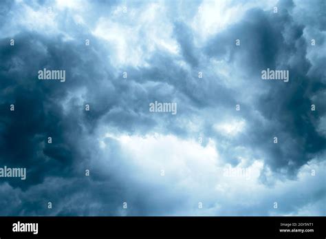 Thick Dark Black Storm Clouds Covering Summer Sunset Sky With Gale