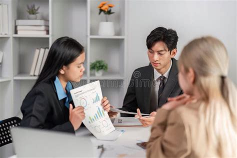 Diverse Business Team Collaborating On Strategic Work Plans In A Modern Office Setting Stock