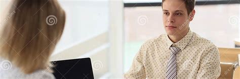 Managers Pass Documents To Each Other While Sitting At Their Desks