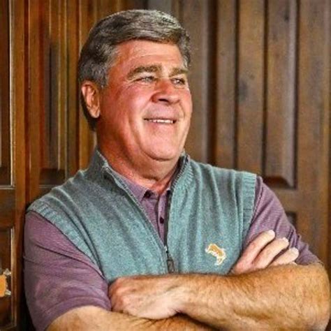 Download Hal Sutton Smiling With Arms Crossed Wallpaper