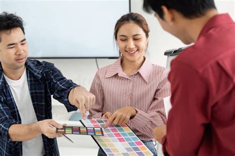 Color Selection And Creativity Team Discussing Color Palettes For A Project Stock Image