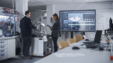 Researchers Working On Robotic Arm In Engineering Laboratory Stock Image F043 4192 Science
