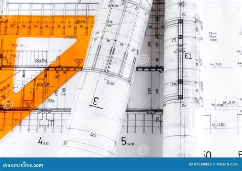 Rolls Of Architectural Blueprints And Floor Plan With Drawing Compass
