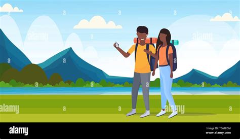 Couple Tourists Hikers Using Compass Searching Direction Hiking Concept