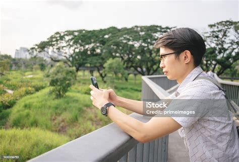 휴대 전화에 텍스트를 입력하는 젊은 아시아 성인 남자 업로드 사진 젊은 아시아 성인 남자 휴대 전화에 텍스트를 입력 자신의 친구
